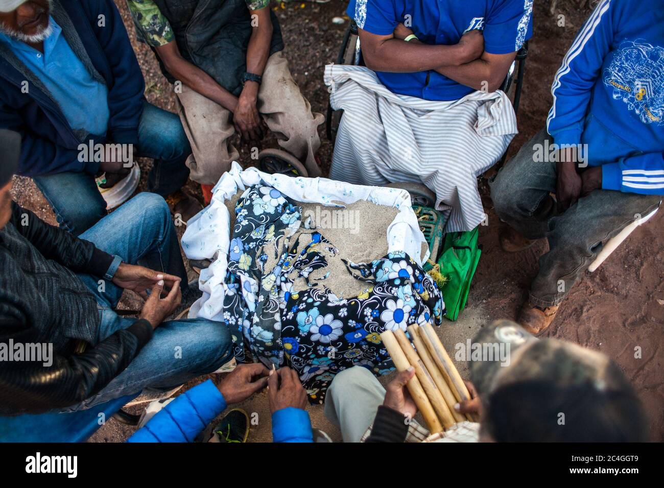 Men of the Comcáac community sit in a circle while playing a game of ...
