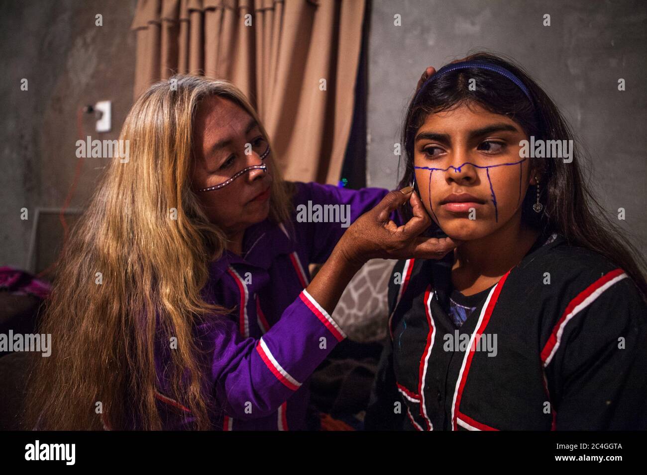 The celebrated girl gets her face painted by her godmother with ...
