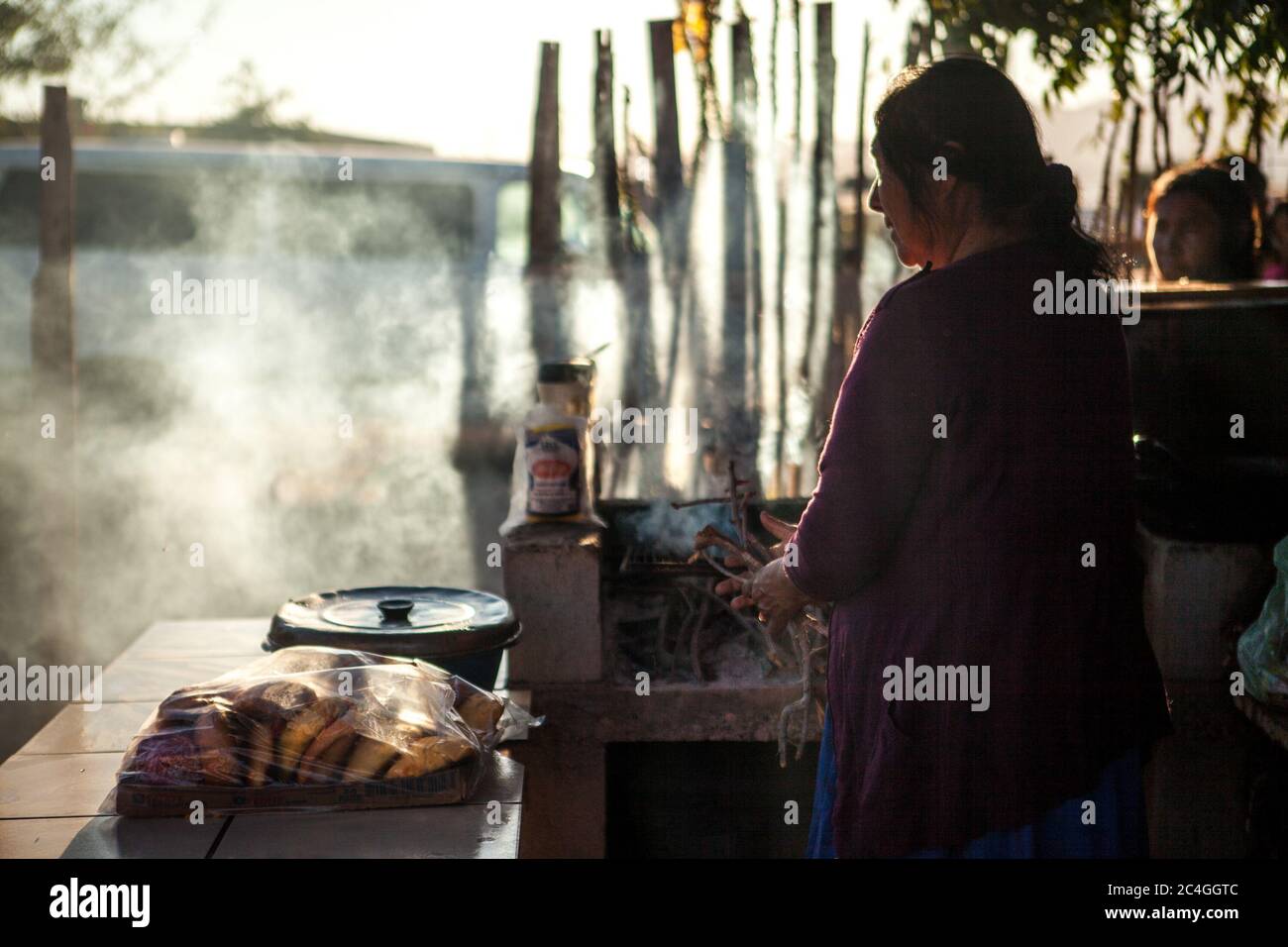 Women of the Comcáac community prepare food for the event on a wood ...