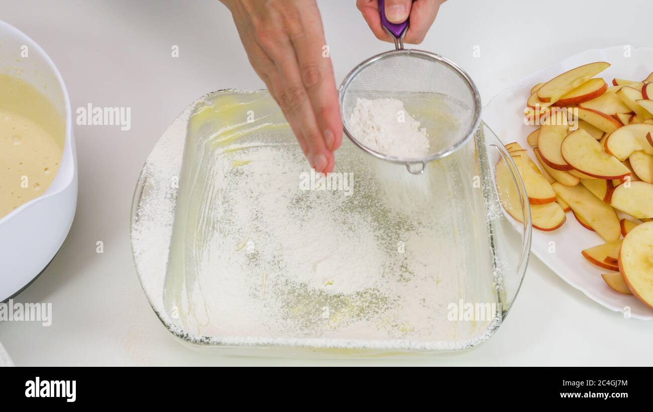 Biscuit batter preparation process. Woman spreads butter and flour over ...