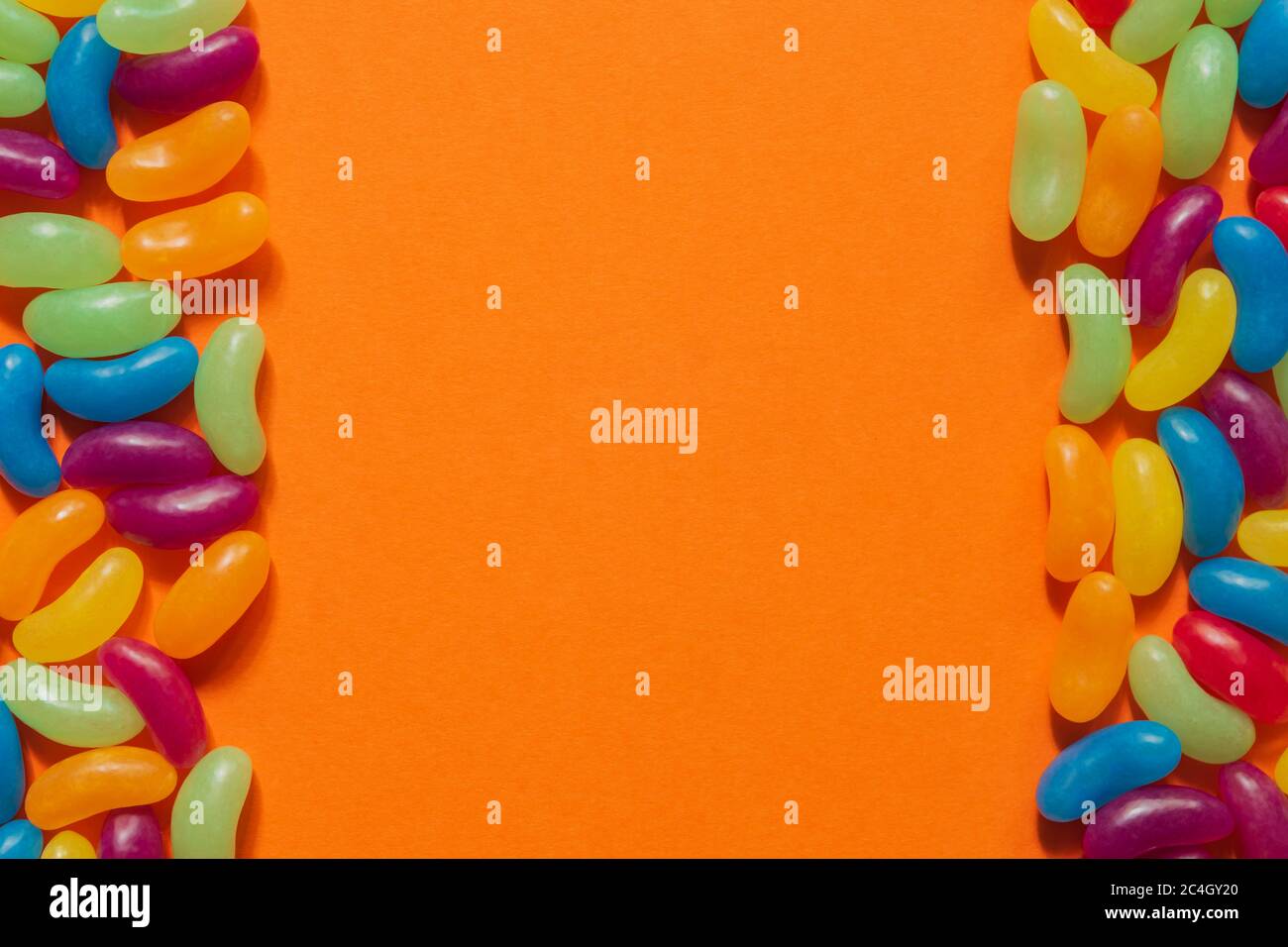Assorted Jelly Beans border with copyspace on orange background Stock ...