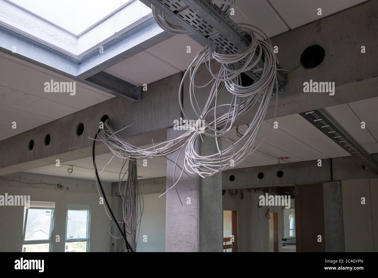 on a construction site of a factory building the thick cable harnesses ...