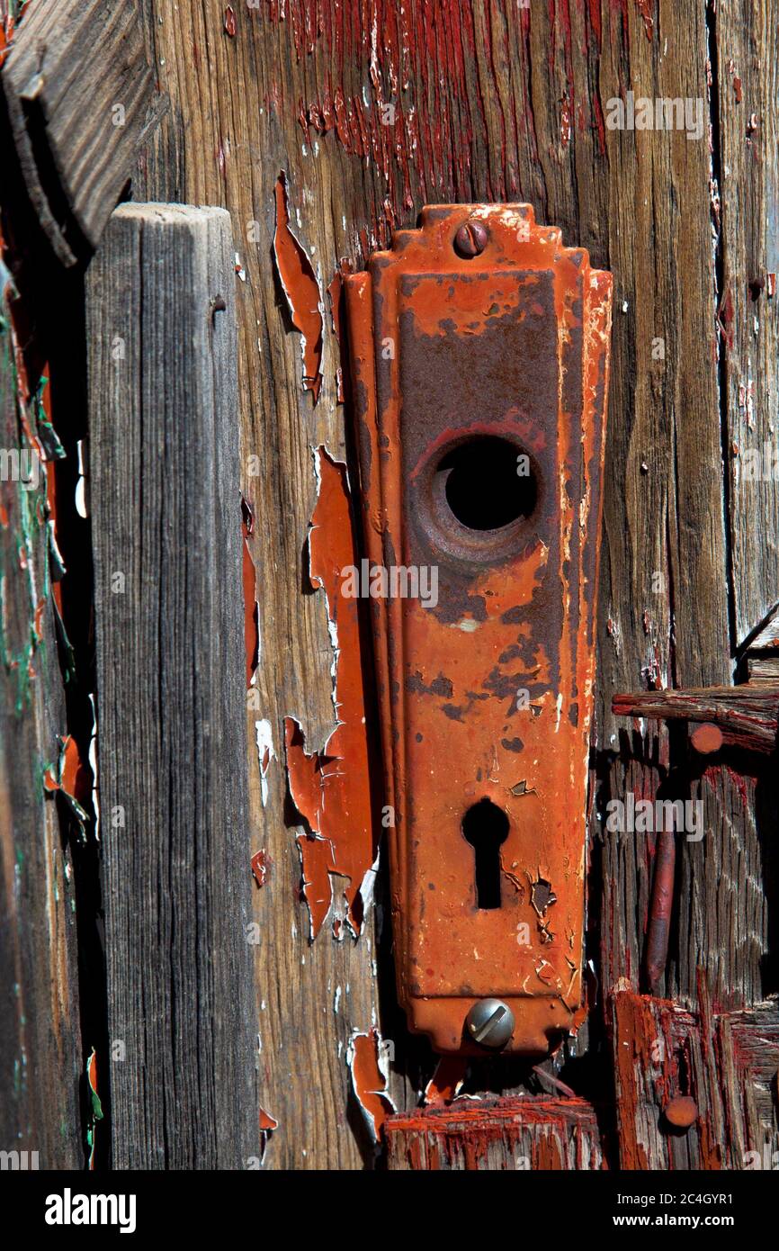 rugged wood door frames on inside of old barn door with peeling red ...