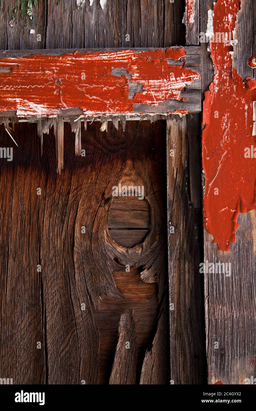 rugged wood door frames on inside of old barn door with peeling red ...