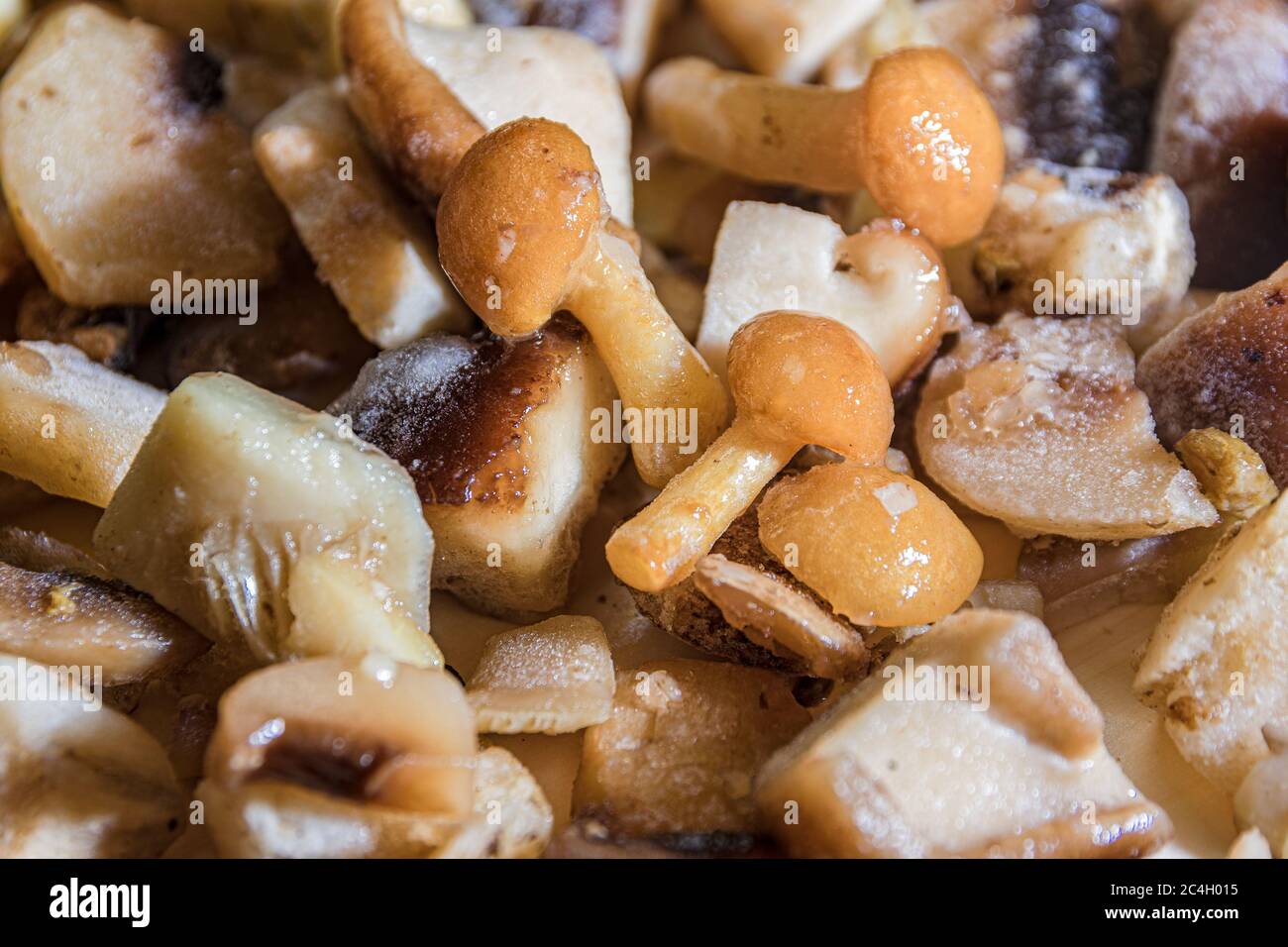 Frozen food. Background of frozen slices of forest mushrooms on the ...