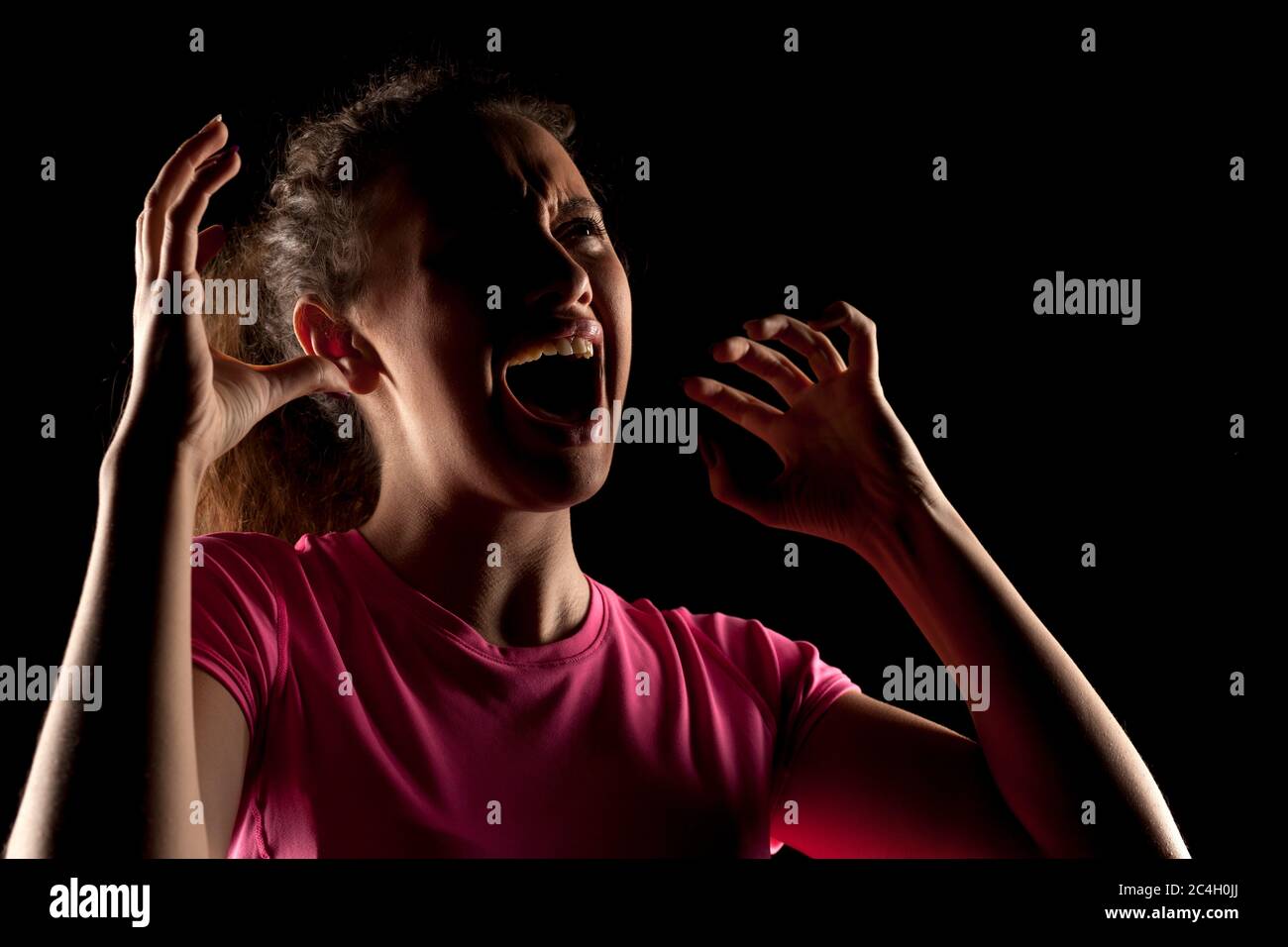 screaming unknown woman with the face in the shadow Stock Photo - Alamy