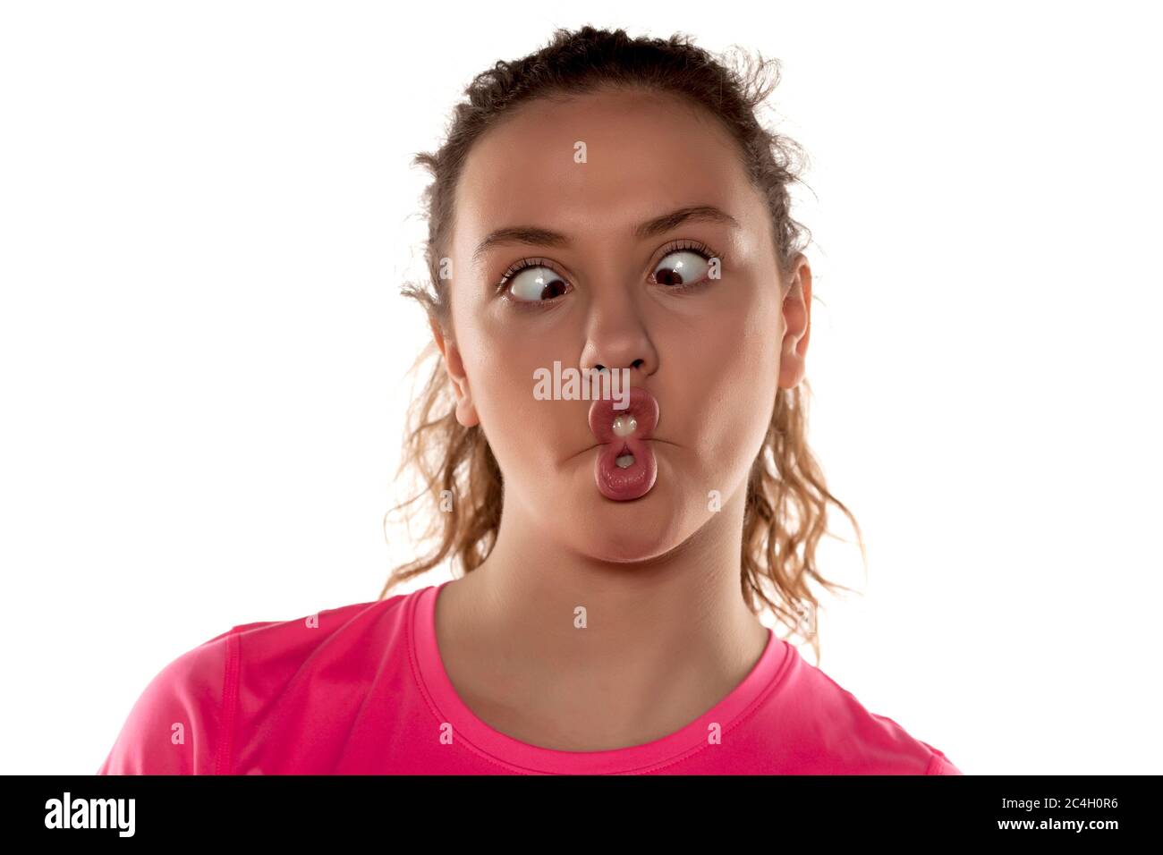 funny young woman making fish face on white background Stock Photo - Alamy