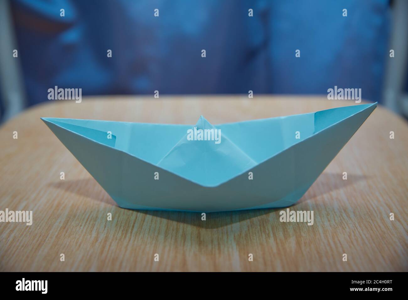 Leadership concept with blue paper ship leading among wooden . Blue ...