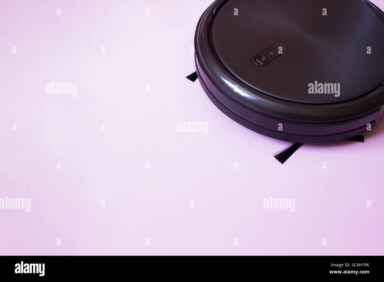 Robotic vacuum cleaner. Close-Up Of Autonomous Robot On pink background ...
