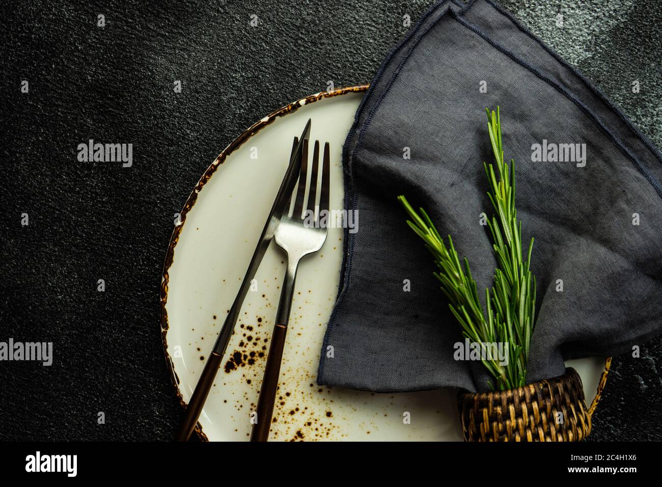 Table setting with ceramic plate and cutlery decorated with fresh ...