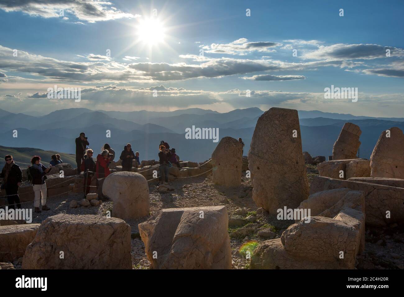 Tourists at the western platform at Mount Nemrut in Turkey. Stone ...