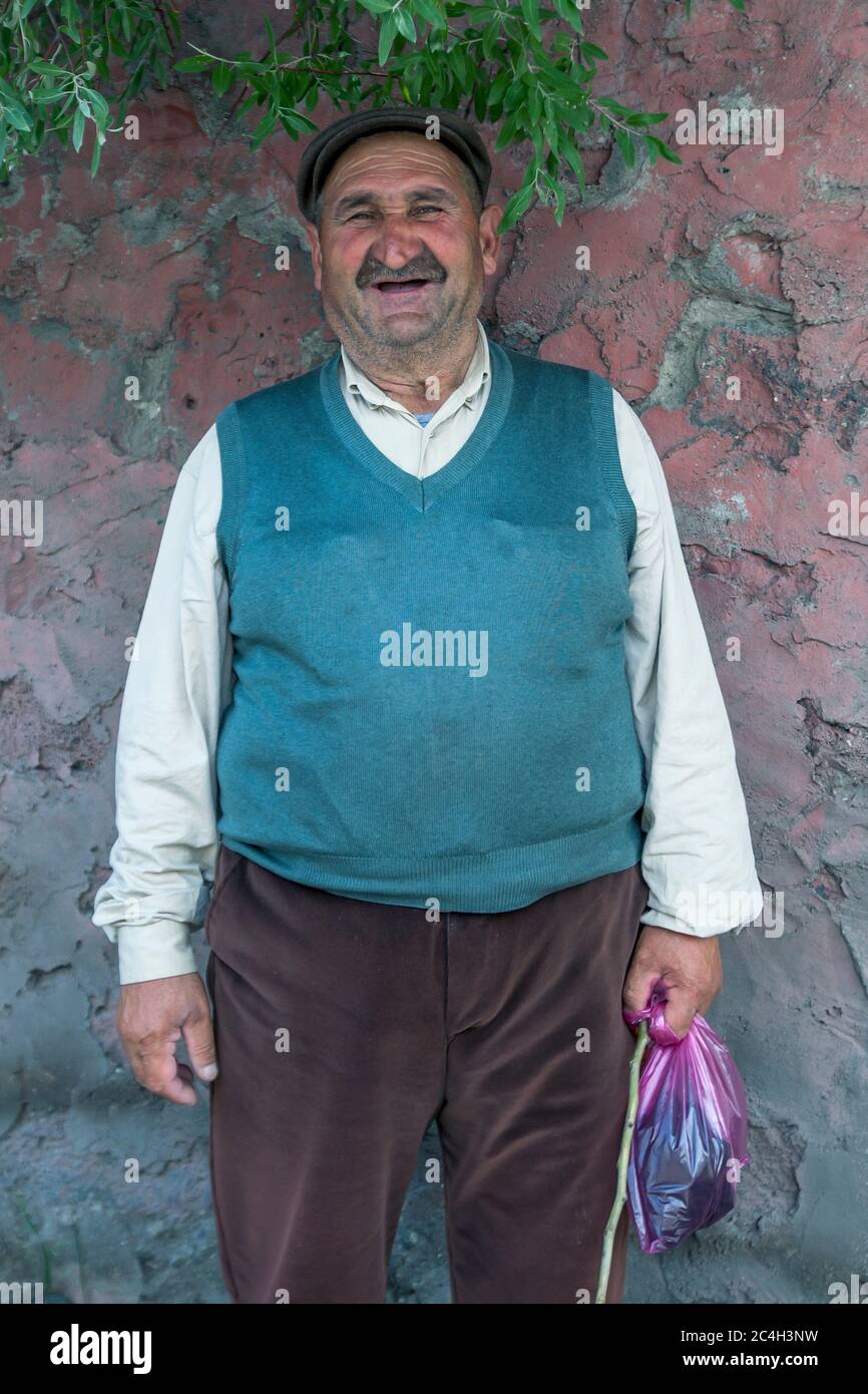 A smiling Kurdish man poses for the camera in the town of Kars, in the ...