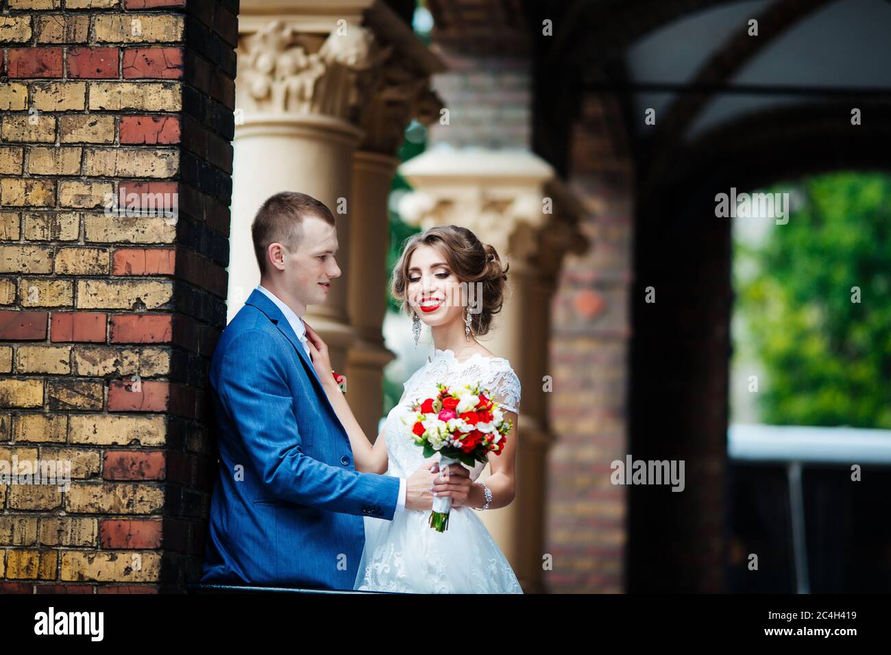 Elegant bride and groom posing together outdoors on a wedding day Stock ...