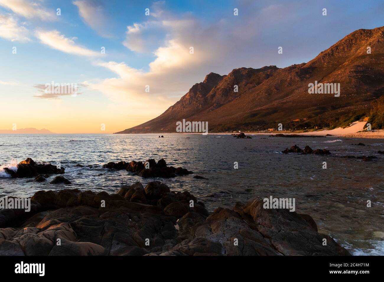 Sunset at False Bay (South Africa) with clouds and boulders on the ...