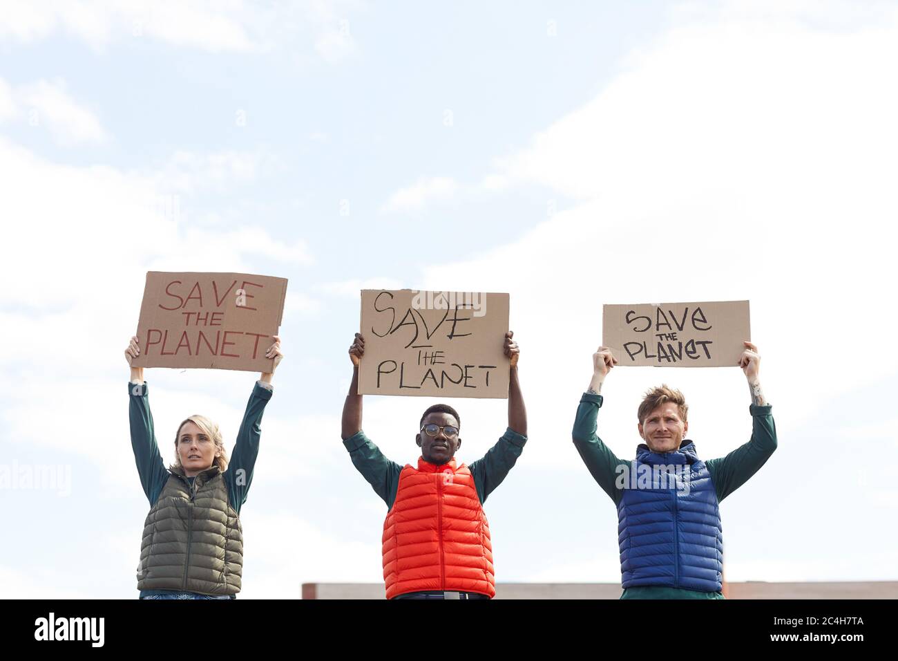 Group of people raising their placards up they standing outdoors Stock ...