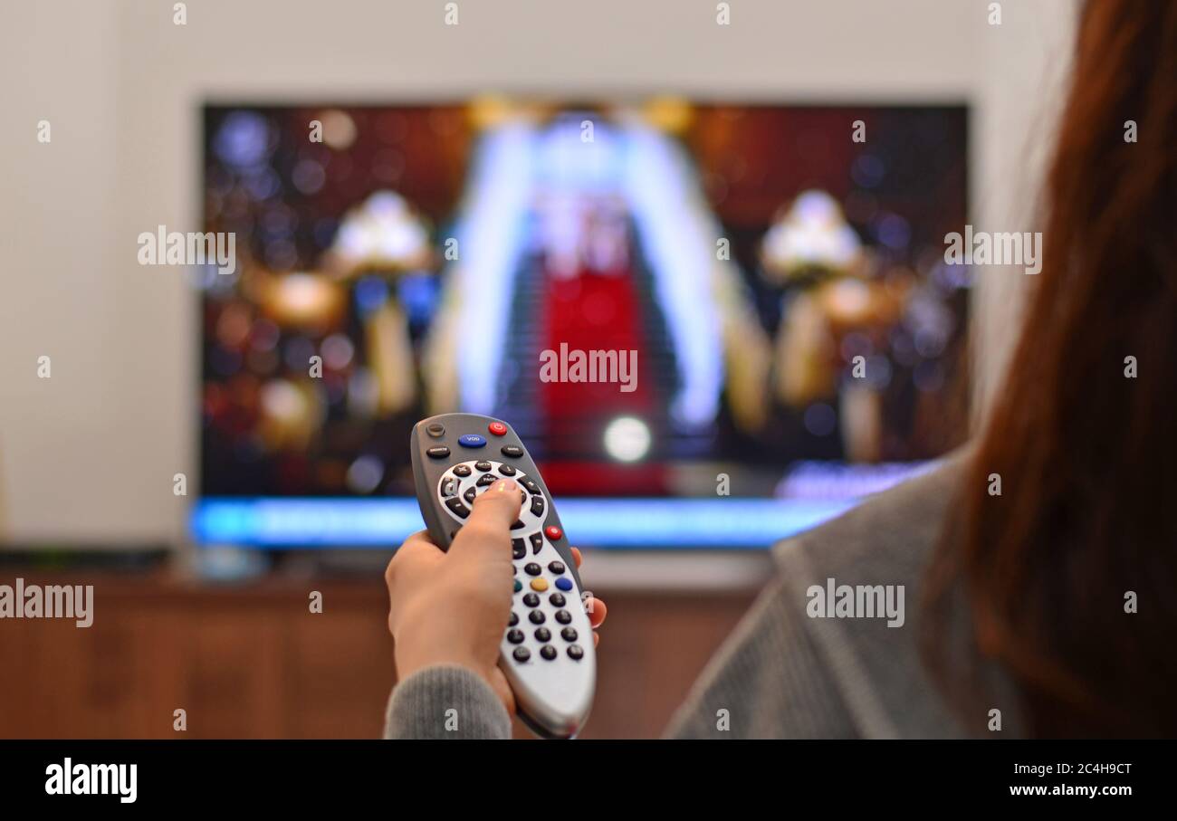 Women watching tv shows and use remote controller Stock Photo - Alamy