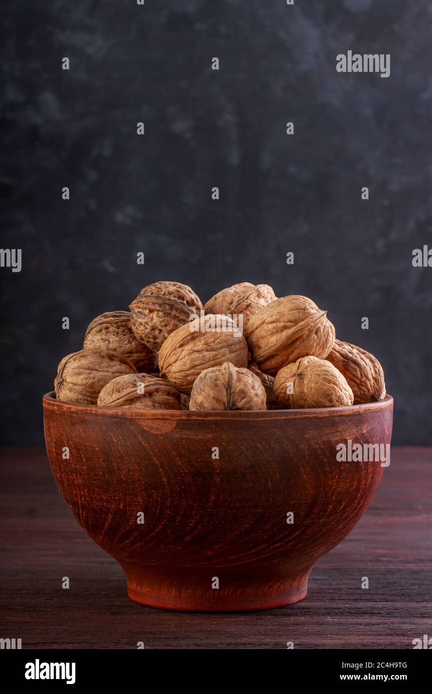 Walnut oret in a clay bowl with a place under the text Stock Photo - Alamy