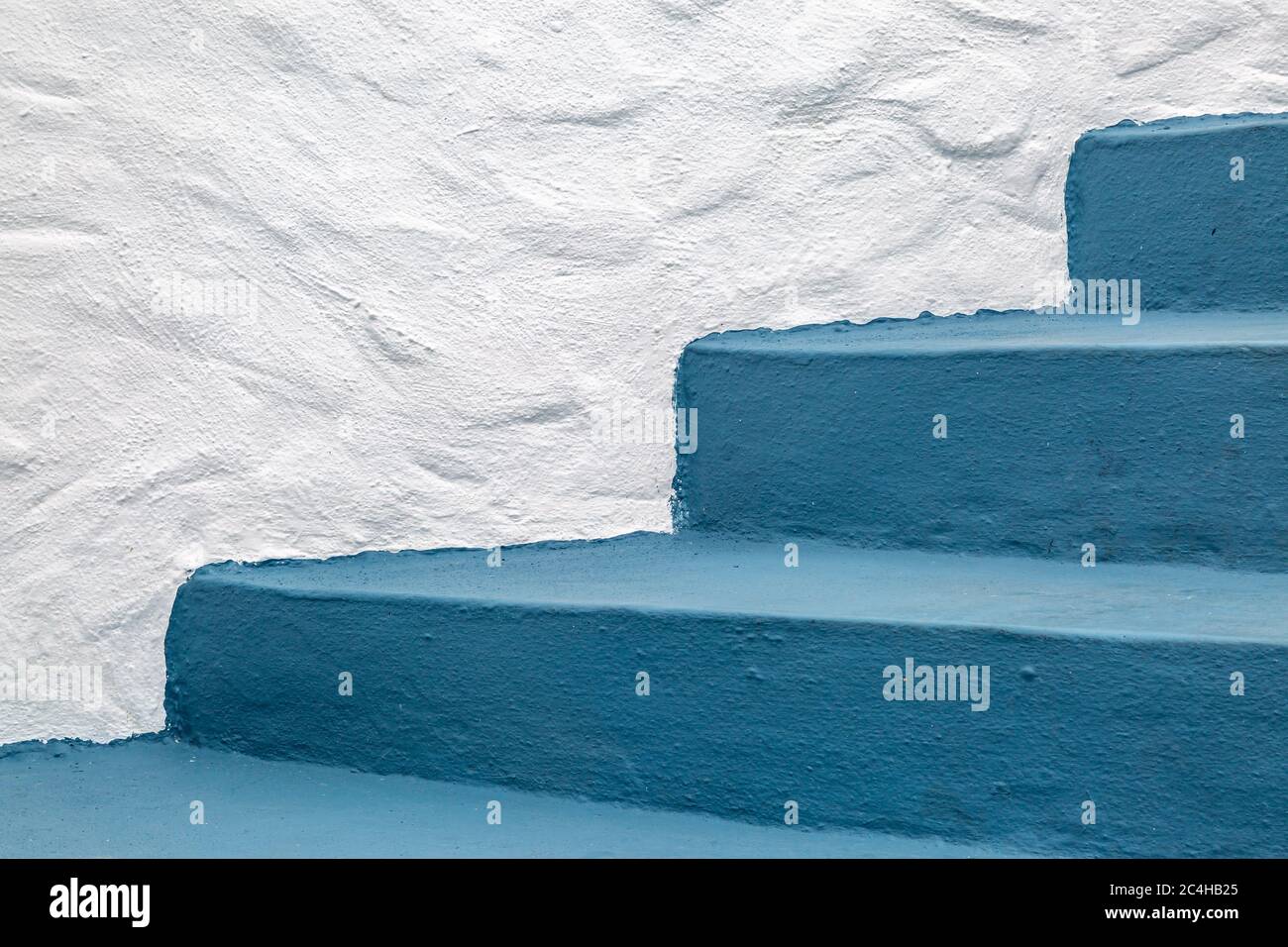 Painted blue steps and a white wall on the outside of a building Stock ...