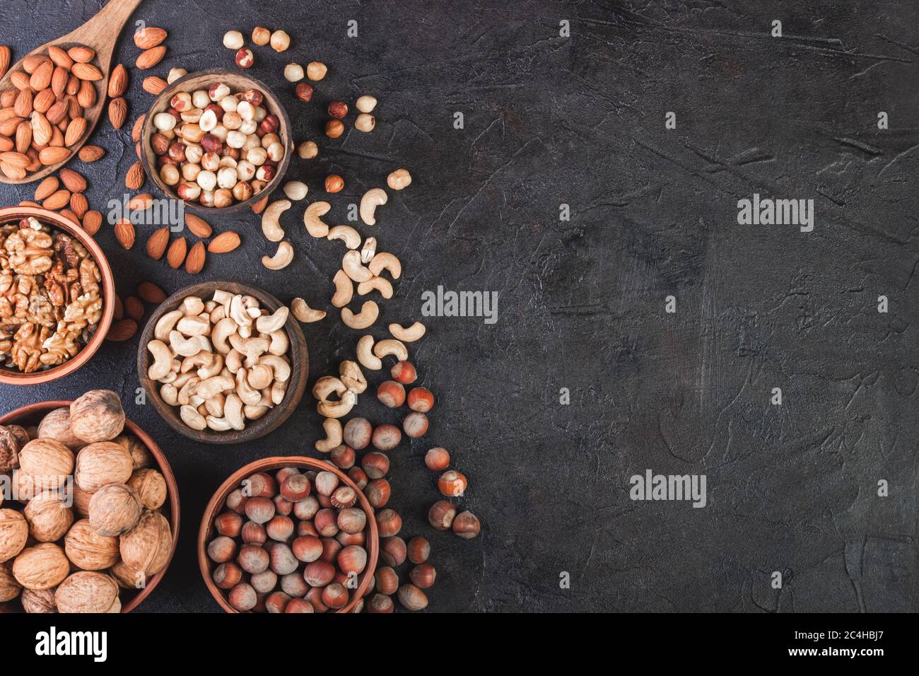 Different nuts in dishes, walnuts, hazelnuts, cashews and almonds Stock ...