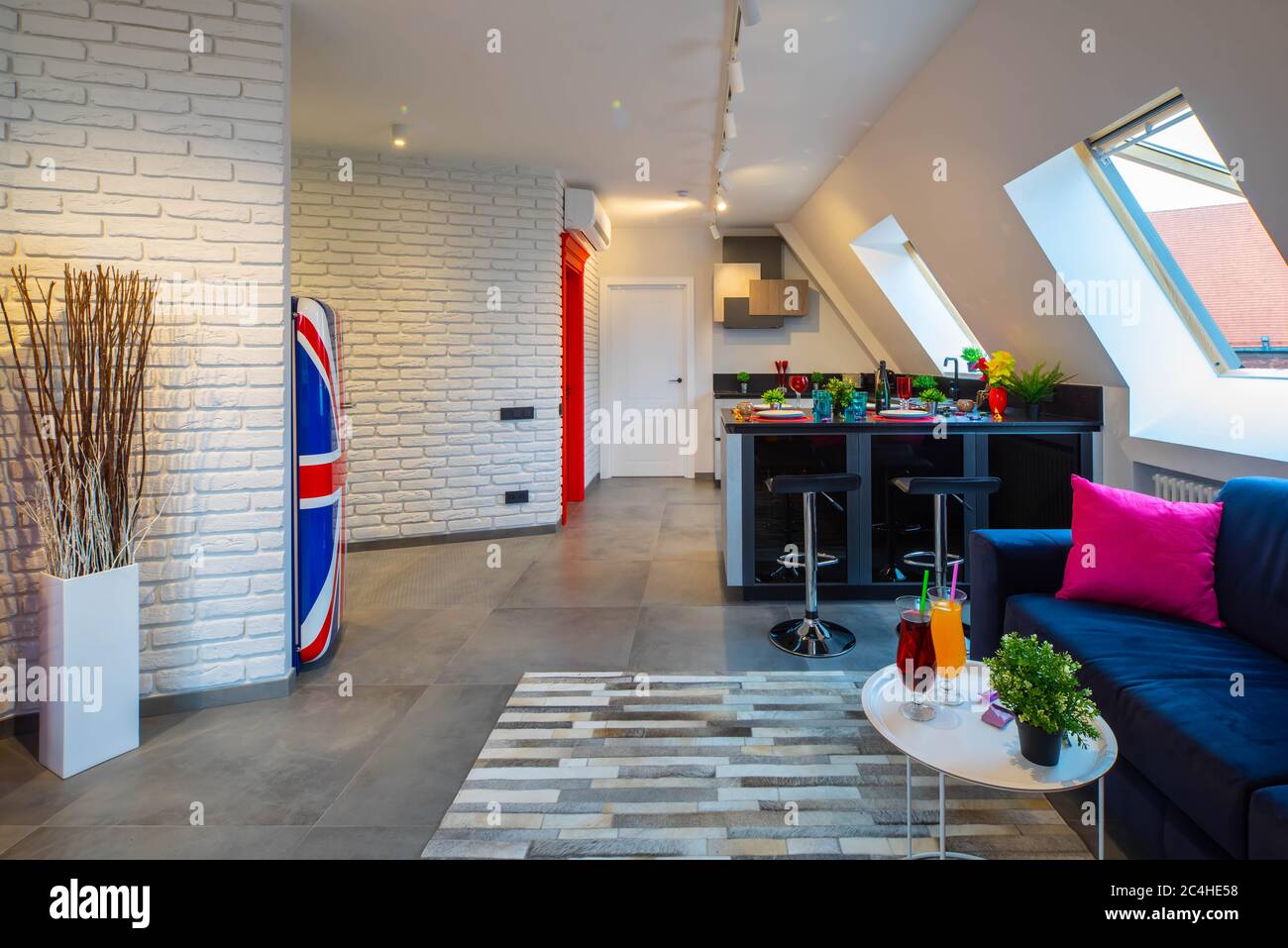 Modern loft interior of luxury studio apartment. Sloping ceiling with ...