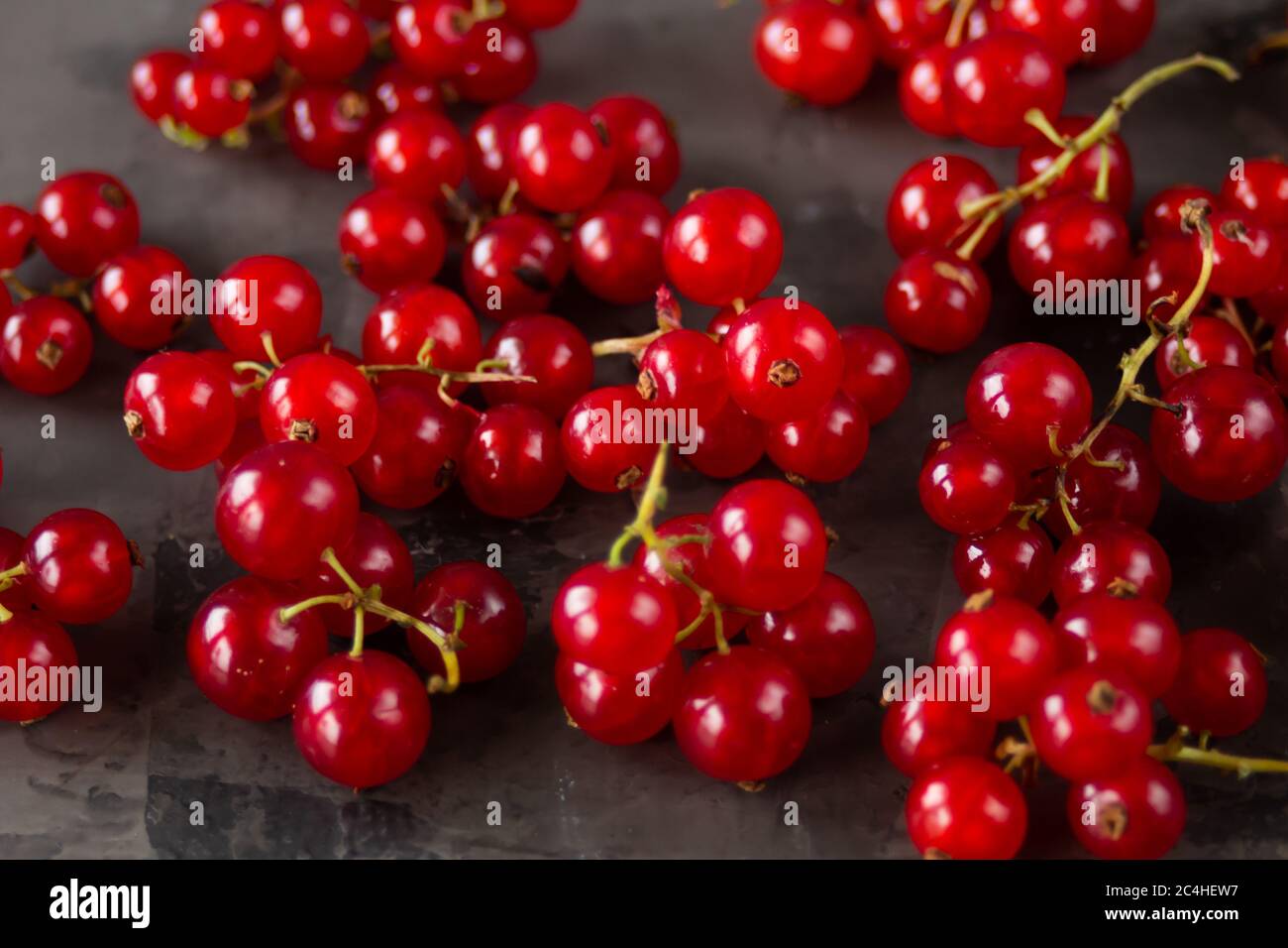 Red currants scattered over a gray texture background. High quality ...
