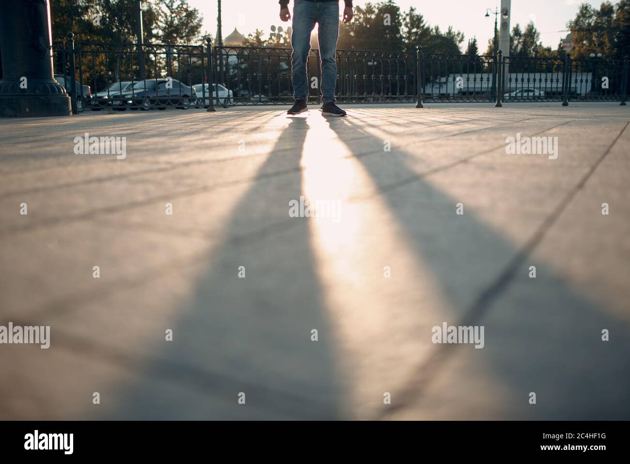 Legs and shadow of pedestrian on city street Stock Photo - Alamy