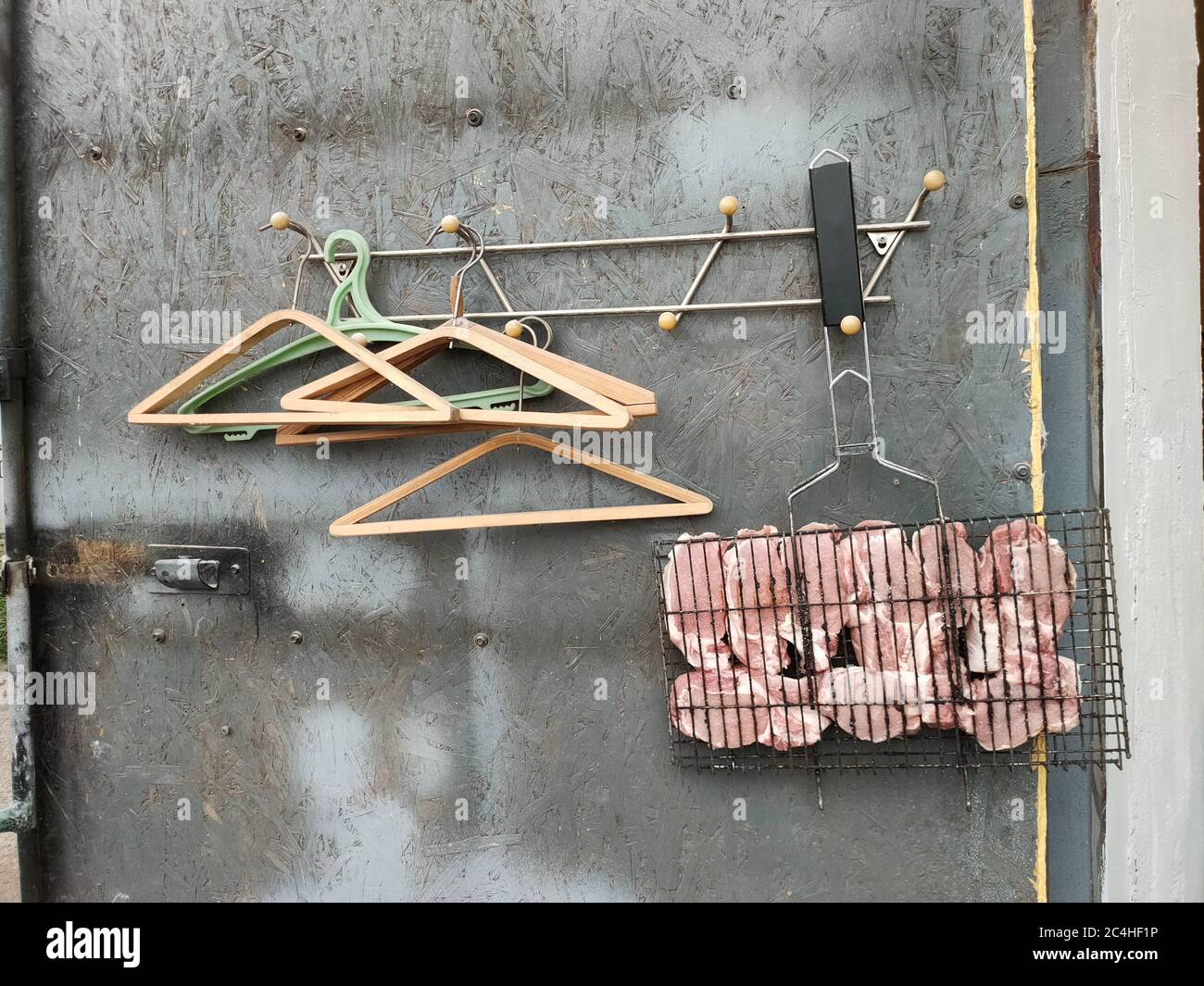 Fresh raw meat grill grid hanging on hook for rack clothes Stock Photo ...