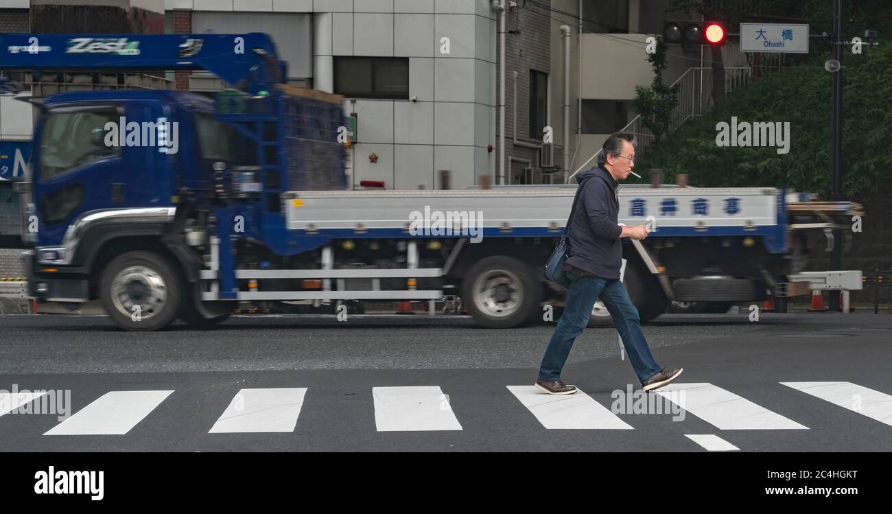Man walking across zebra crossing in the street, Tokyo, Japan Stock ...