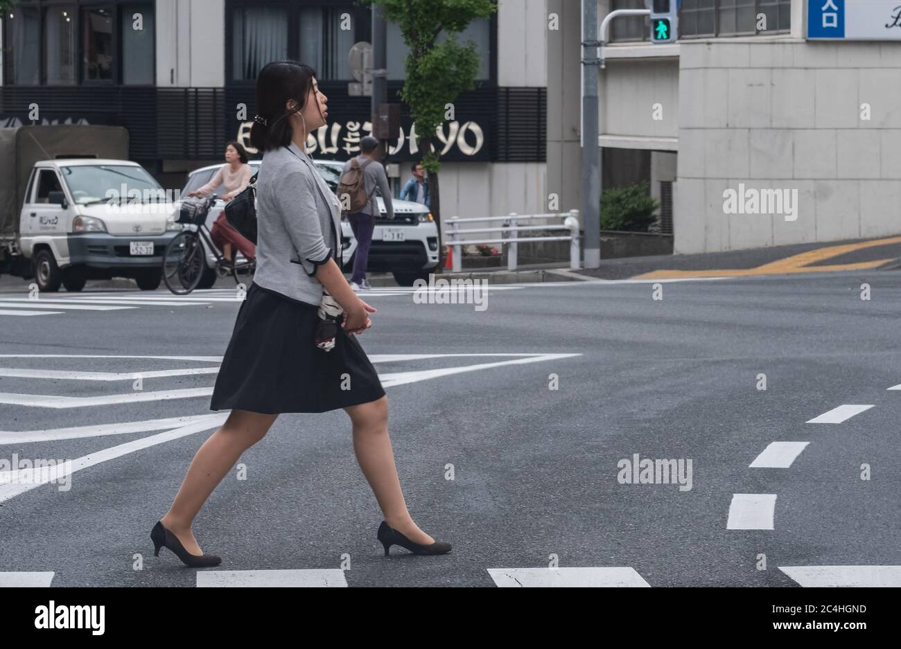 Female office worker crossing the road, Tokyo, Japan Stock Photo - Alamy