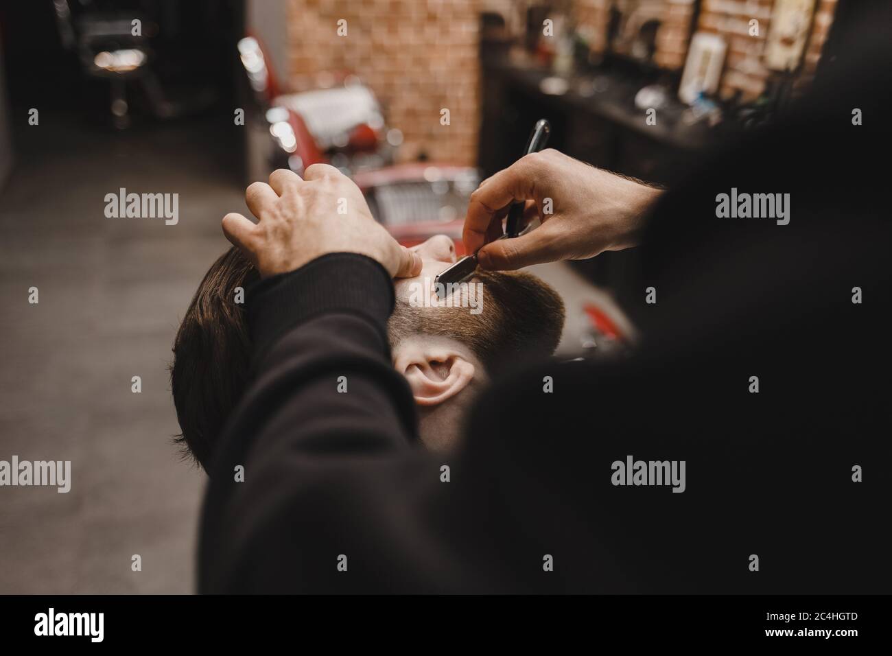 Beard shaving process in barbershop Stock Photo - Alamy