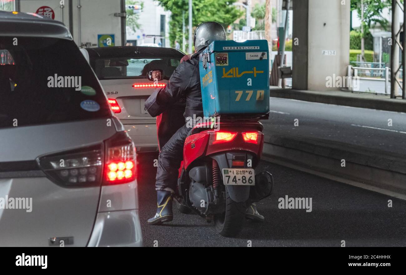 Motorcycle delivery in the street of Tokyo, Japan Stock Photo - Alamy