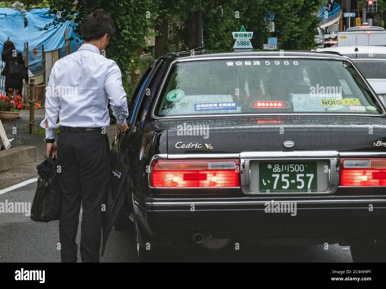 Man boarding a taxi in Tokyo street, Japan Stock Photo - Alamy