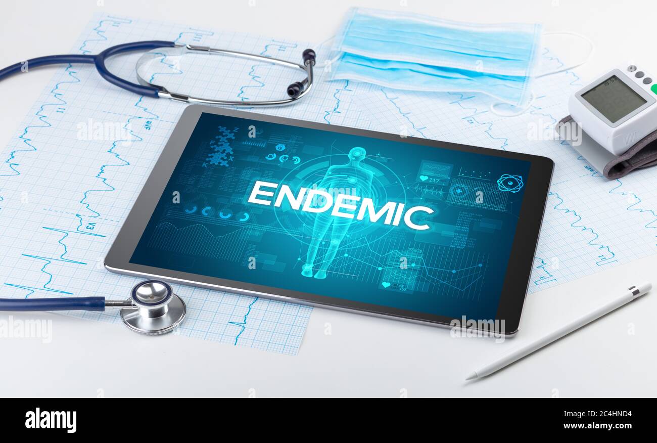 Tablet pc and doctor tools with ENDEMIC inscription, coronavirus ...