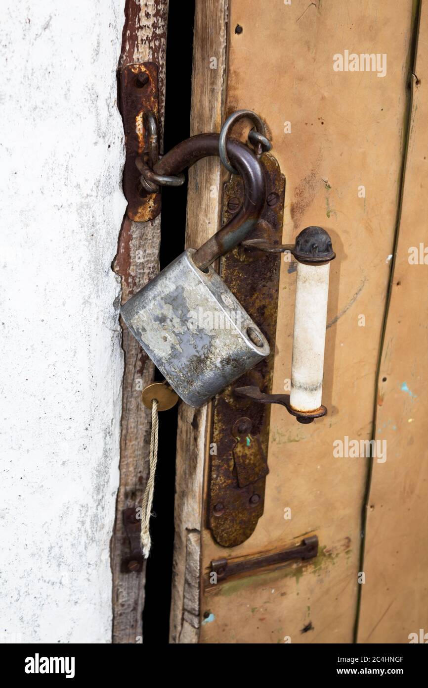 Old lock with a key on the old shabby door Stock Photo - Alamy