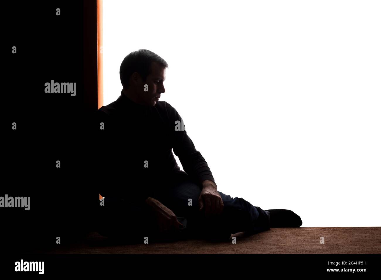 Young man with grief dropped his arms - silhouette Stock Photo - Alamy