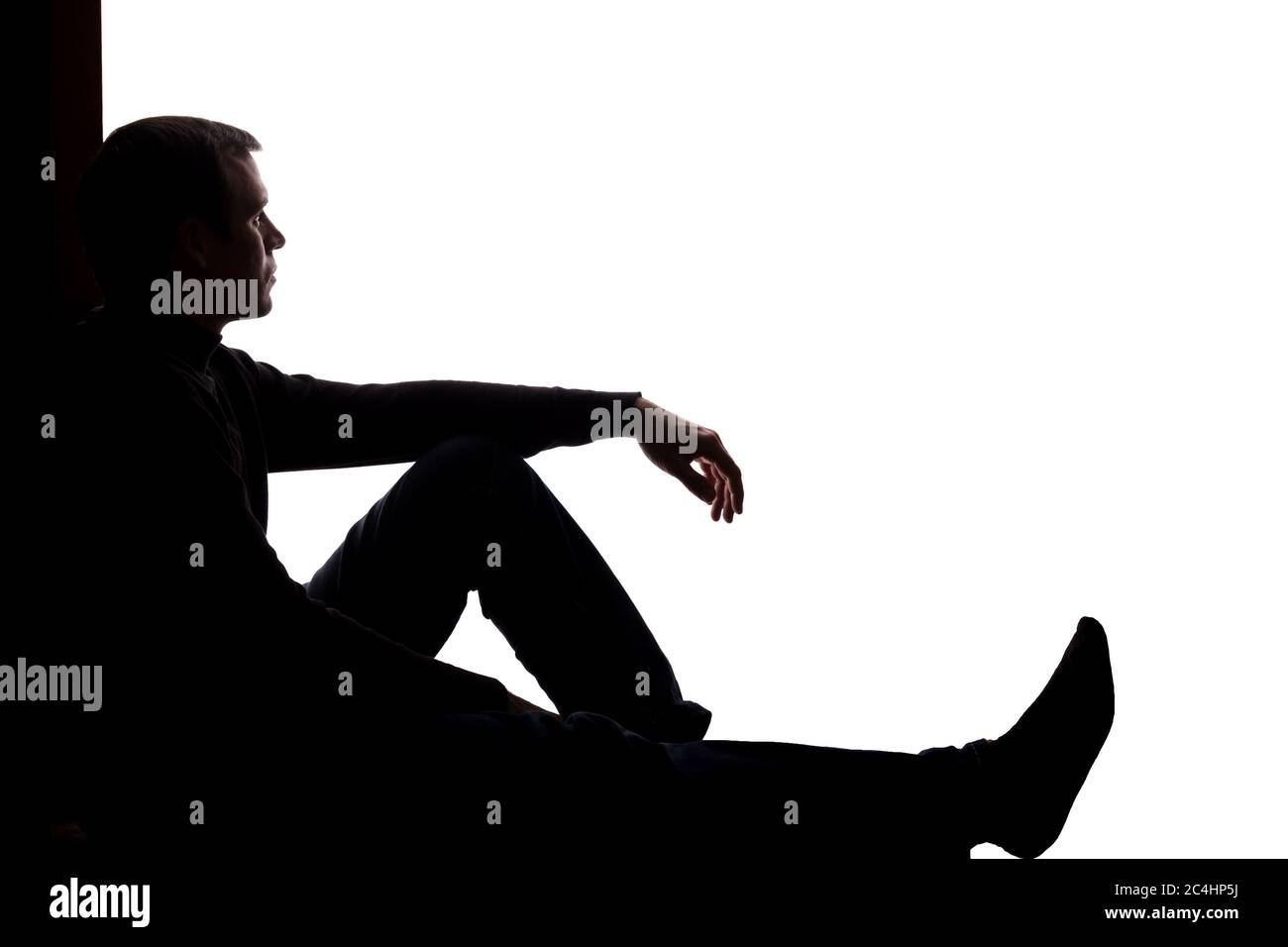 Young man with grief dropped his arms - silhouette Stock Photo - Alamy