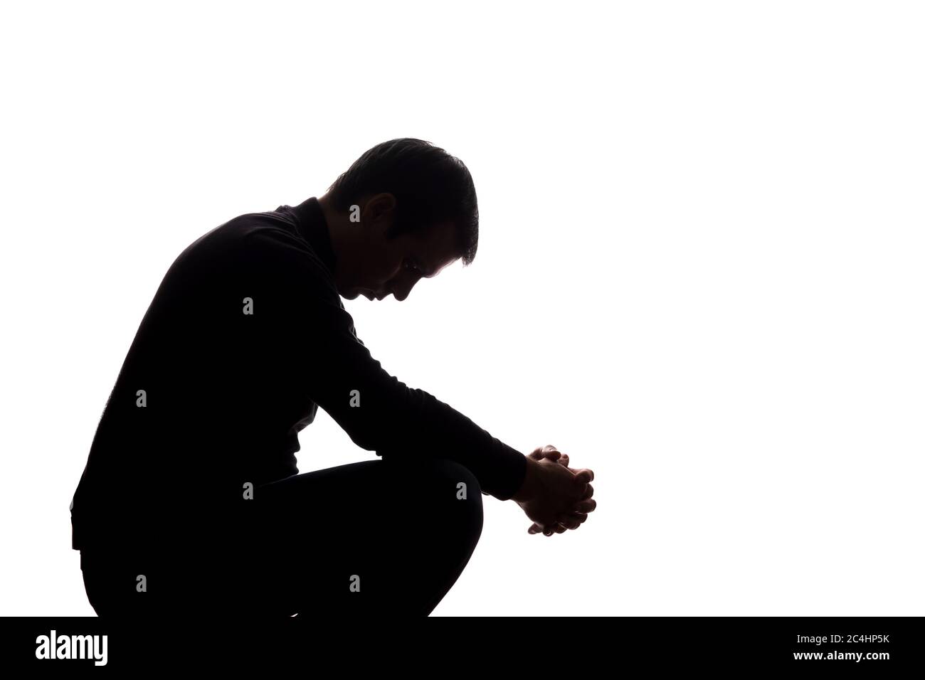 Young man with grief dropped his arms - silhouette Stock Photo - Alamy