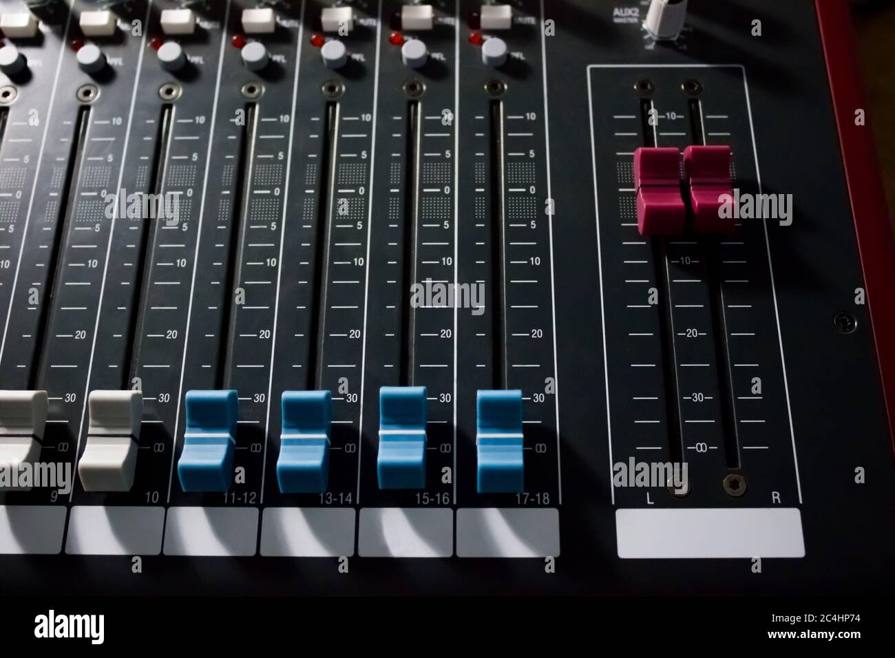 Console of a professional mixer with a lot of controls - music, concert ...
