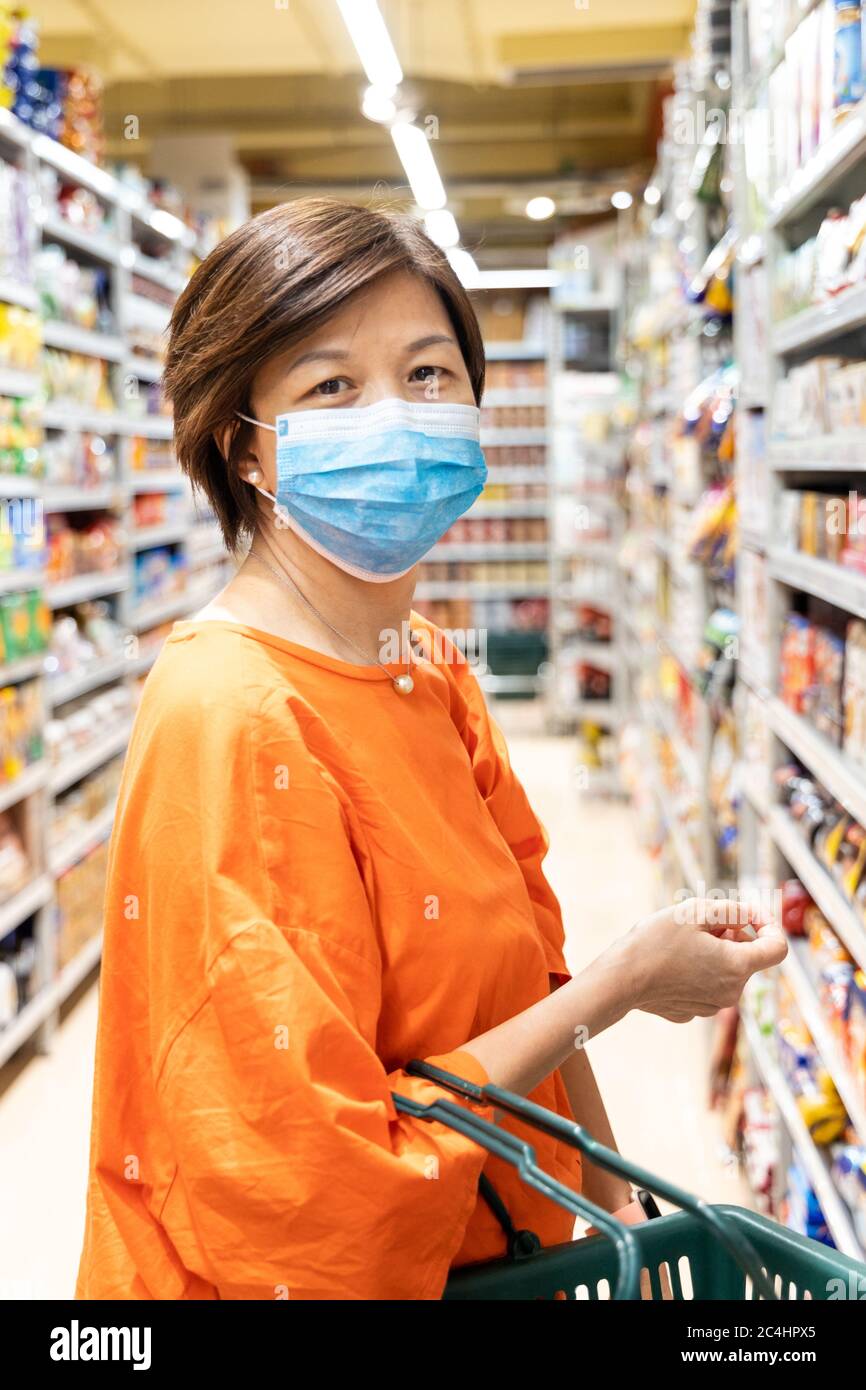 Asian women with face mask for protection against influenza virus ...