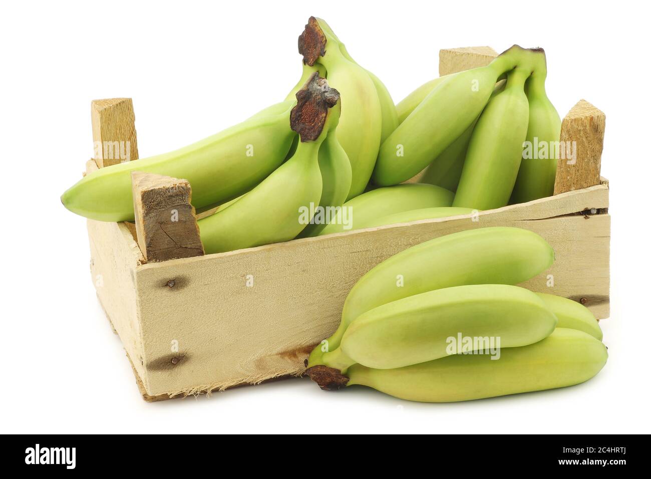 small green snack bananas in a wooden crate on a white background Stock ...
