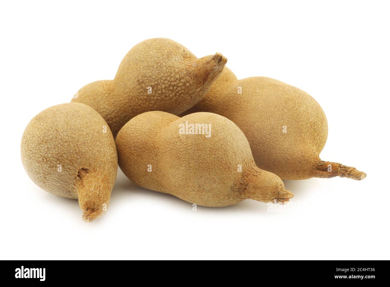 tamarind beans on a white background Stock Photo - Alamy