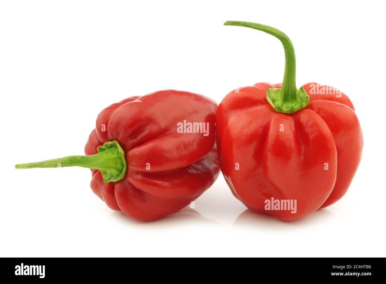 spicy hot red adjuma peppers on a white background Stock Photo - Alamy