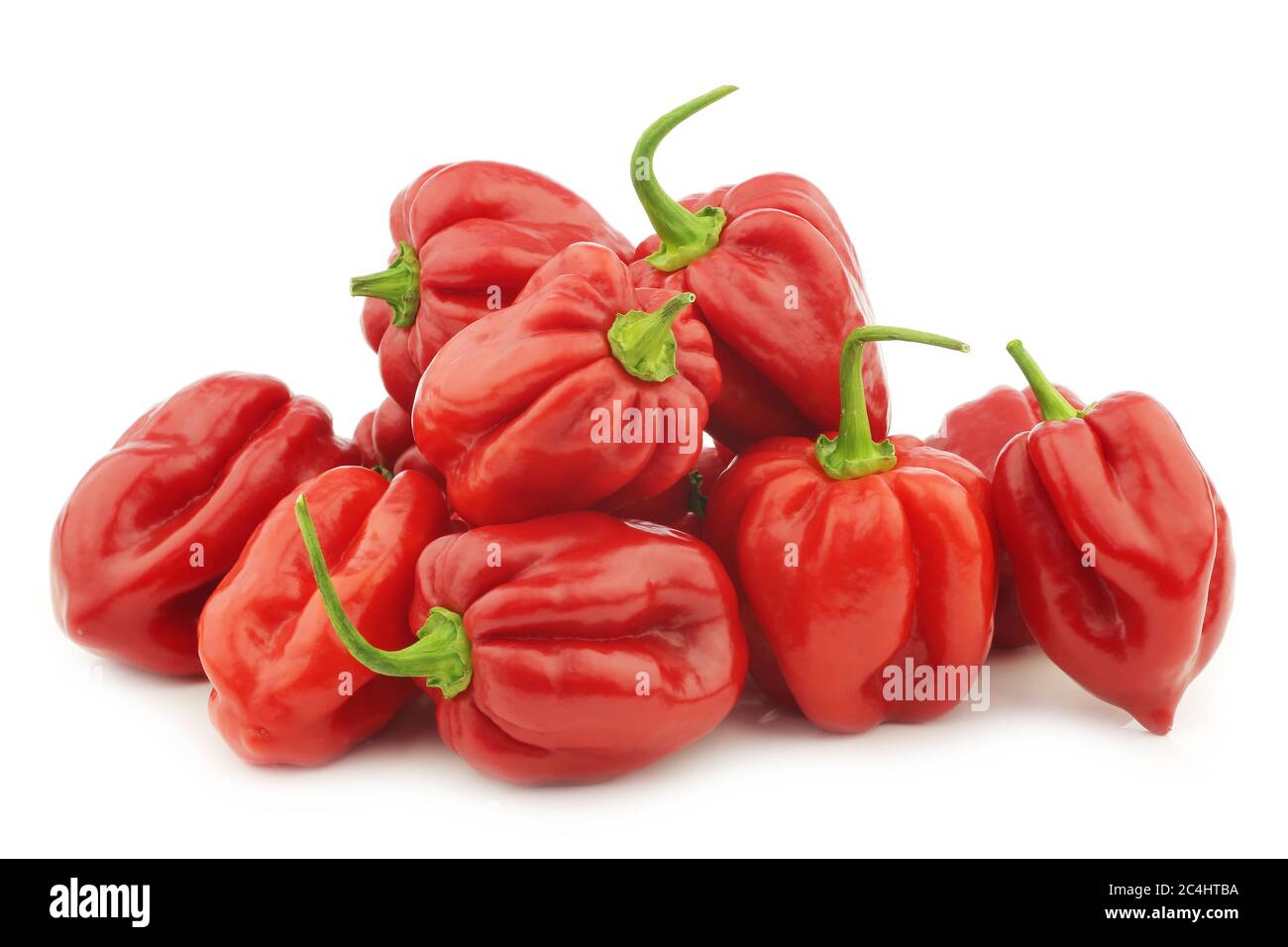spicy hot red adjuma peppers on a white background Stock Photo - Alamy
