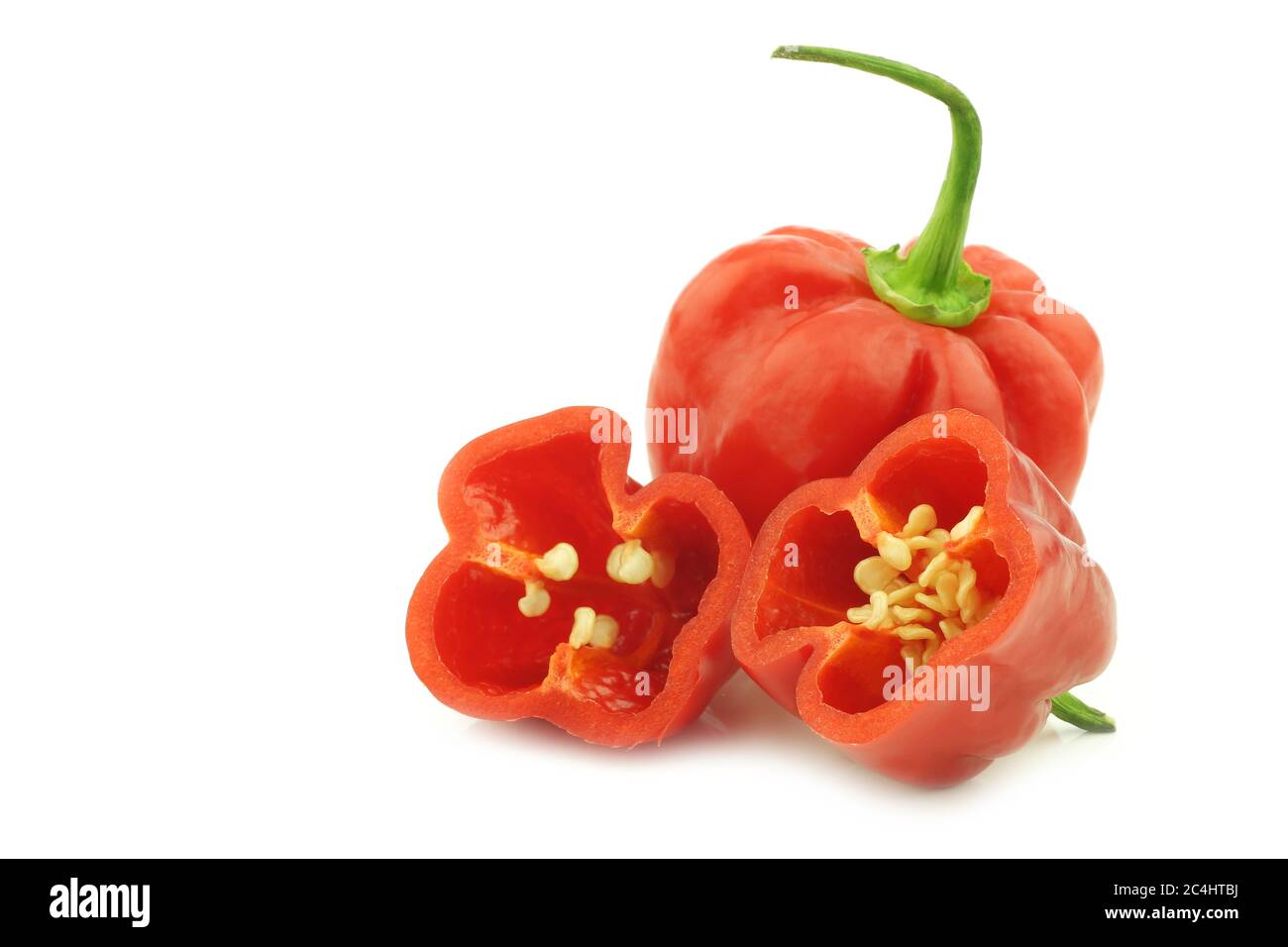 spicy hot red adjuma peppers on a white background Stock Photo - Alamy