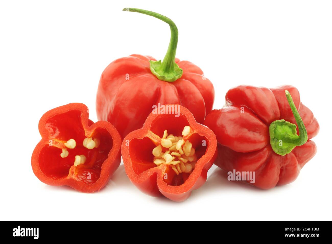 spicy hot red adjuma peppers on a white background Stock Photo - Alamy