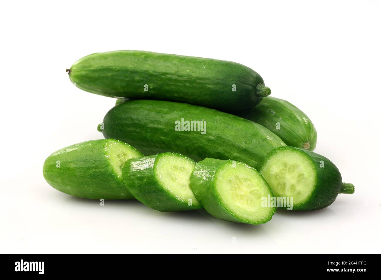 fresh green cut baby cucumbers you can eat as a snack on a white ...