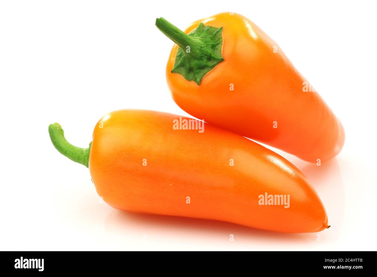 fresh orange peppers (capsicum) on a white background Stock Photo - Alamy