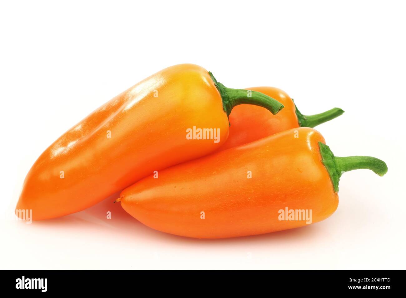 fresh orange peppers (capsicum) on a white background Stock Photo - Alamy