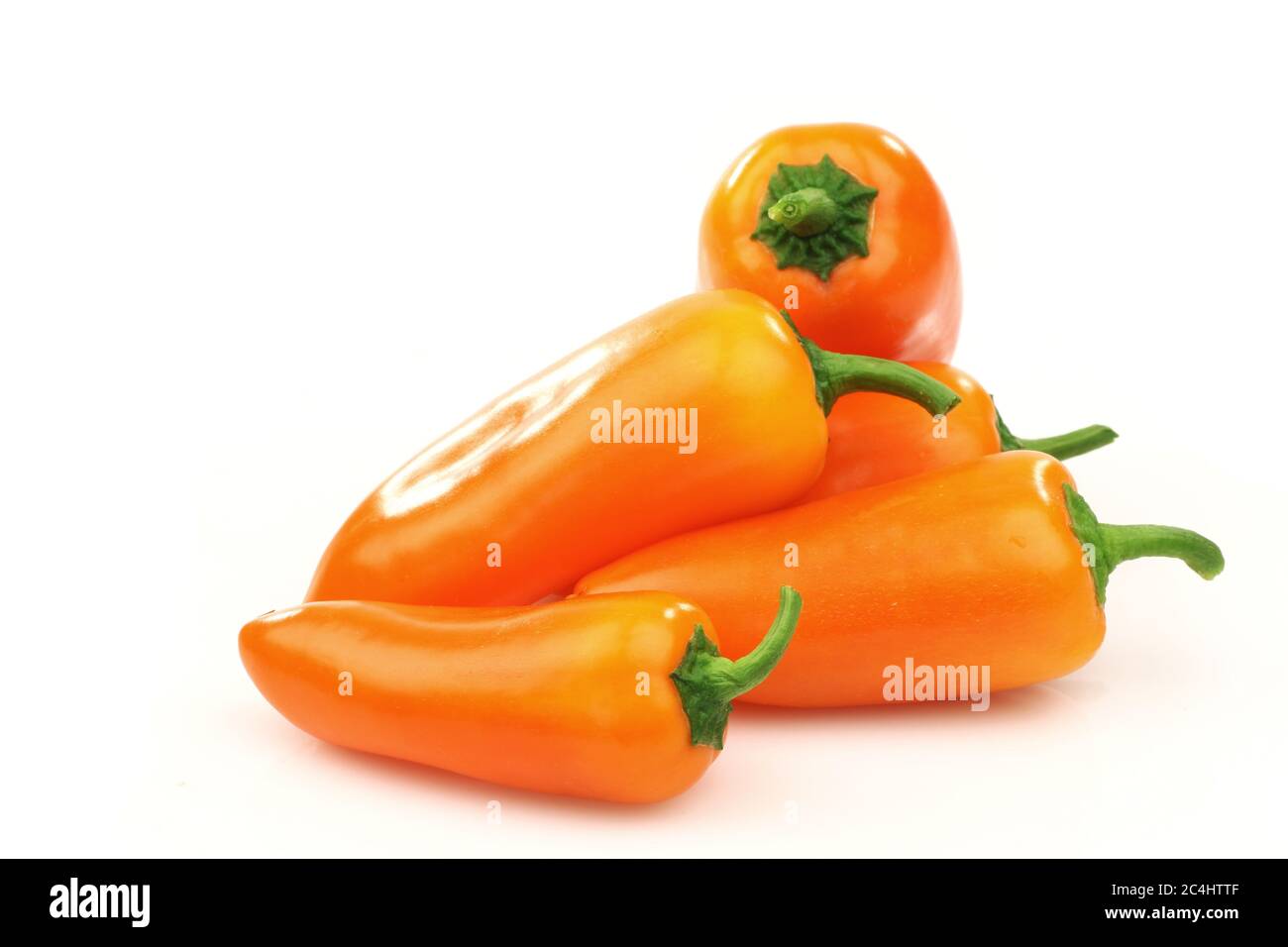fresh orange peppers (capsicum) on a white background Stock Photo - Alamy