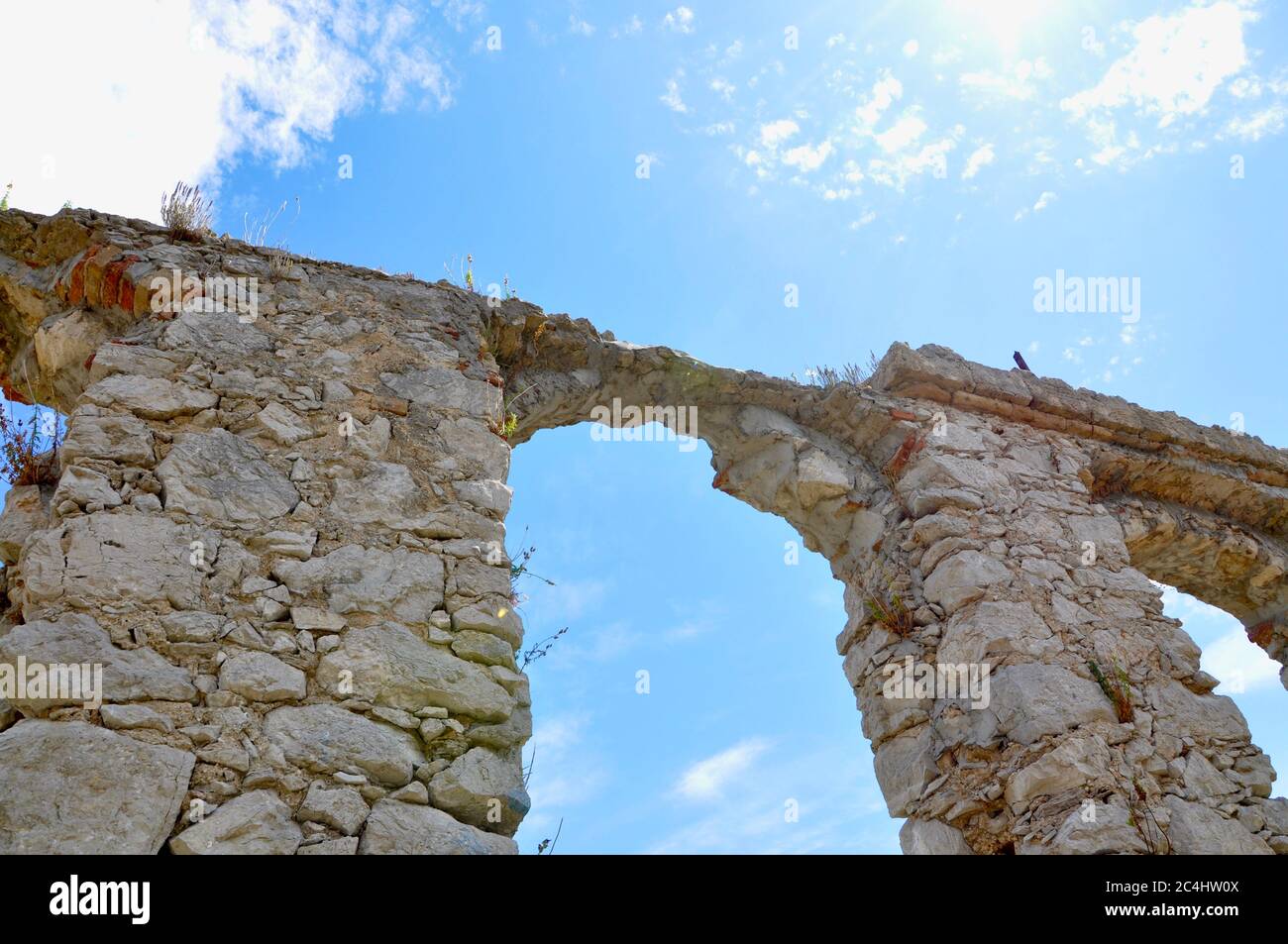 An arch in the ruined wall of the medieval castle Stock Photo - Alamy